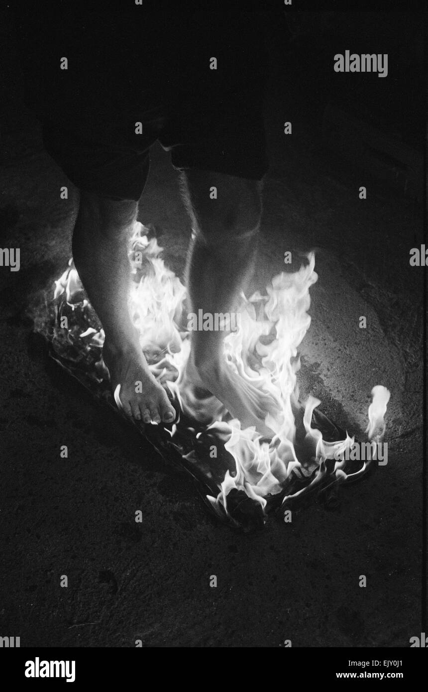 Walking through fire Black and White Stock Photos & Images - Alamy