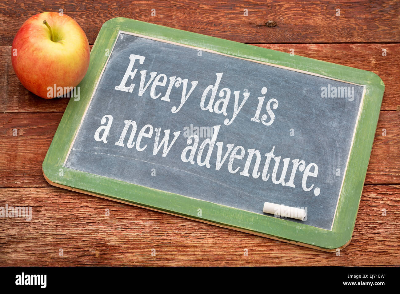 Every day is a new adventure - positive words on a slate blackboard ...