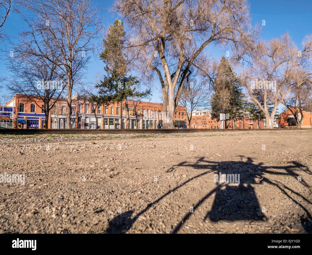 A shadow of quadcopter drone with camera taking off to fly over city ...