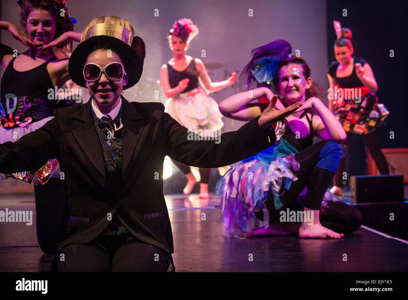 Theatrical performers in various costumes posed on a stage for a ...