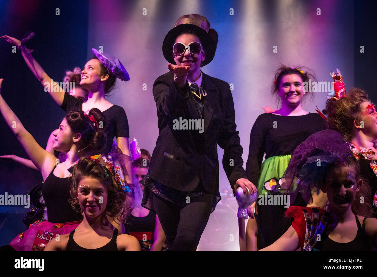 Theatrical performers in various costumes posed on a stage for a ...
