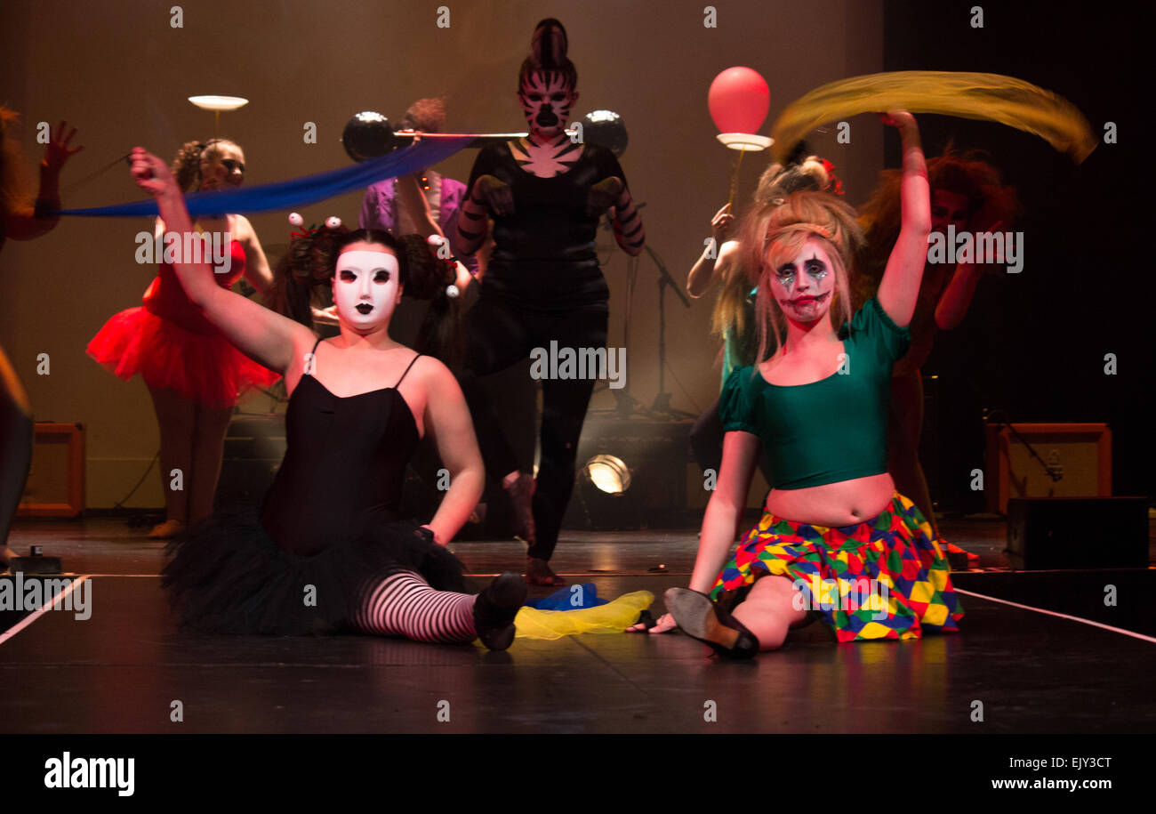 Theatrical performers in various costumes posed on a stage for a ...