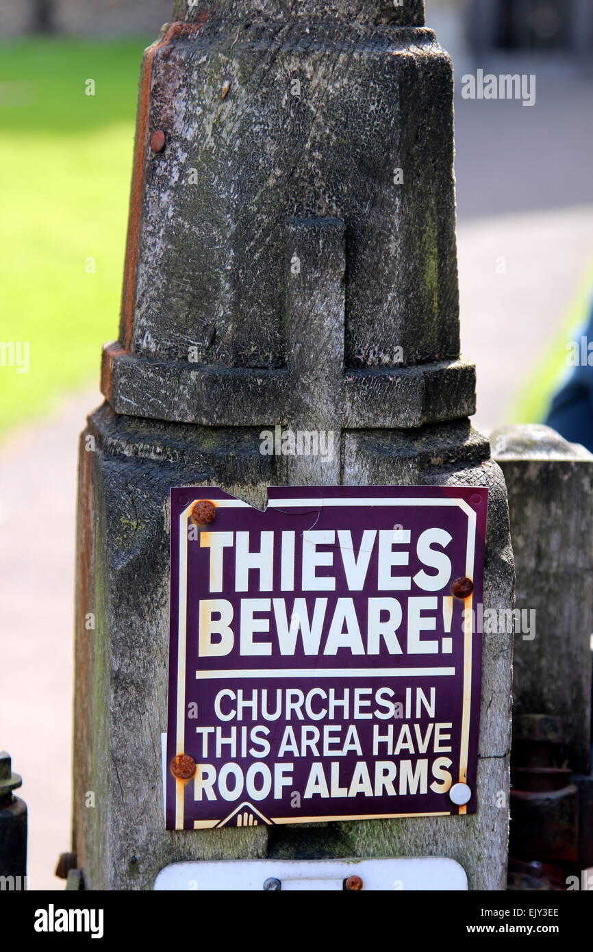 Warning sign on a concrete post Stock Photo - Alamy