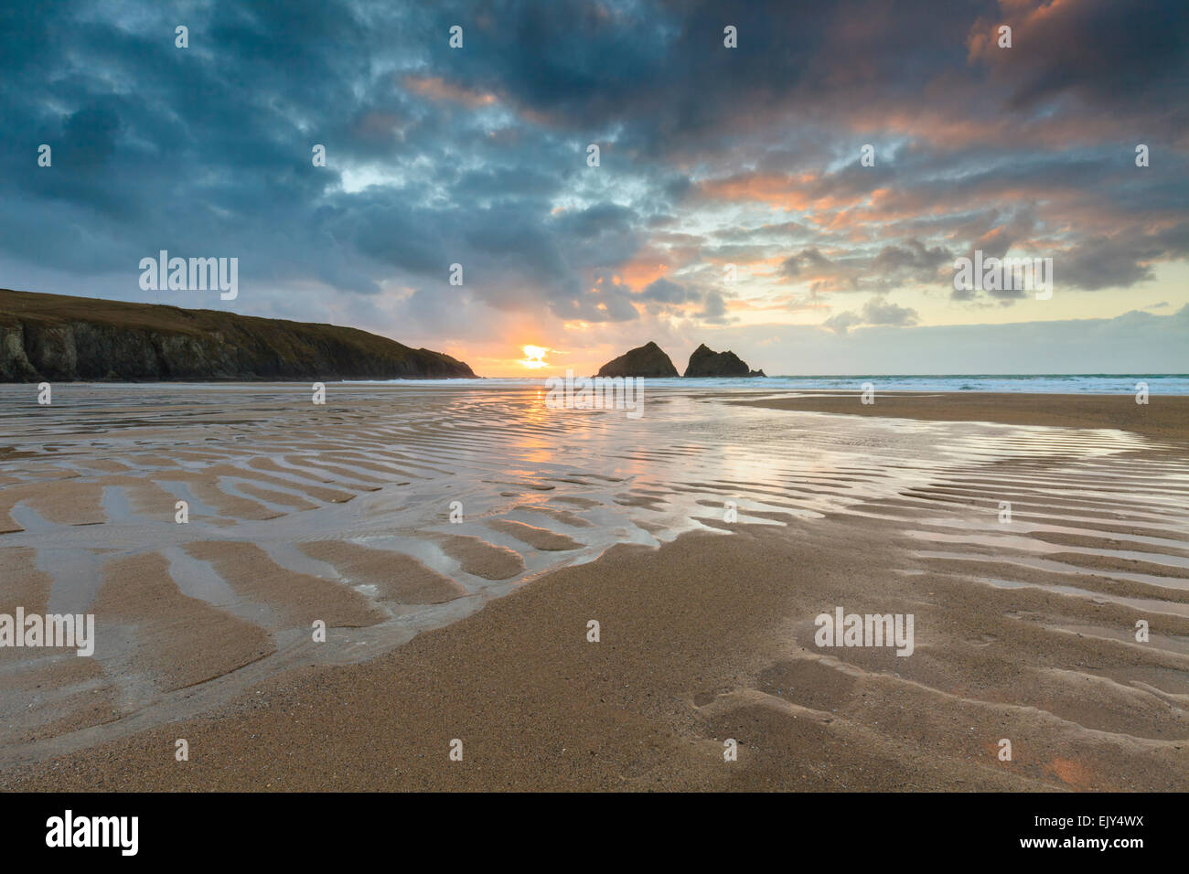 The beach at Holywell Bay, captured at sunset Stock Photo - Alamy