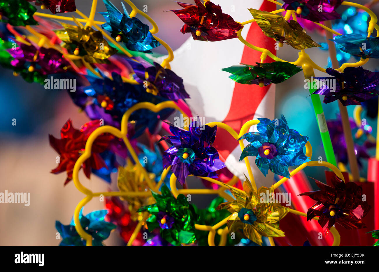 Small decorated wind turbine toys on display on the seafront in ...