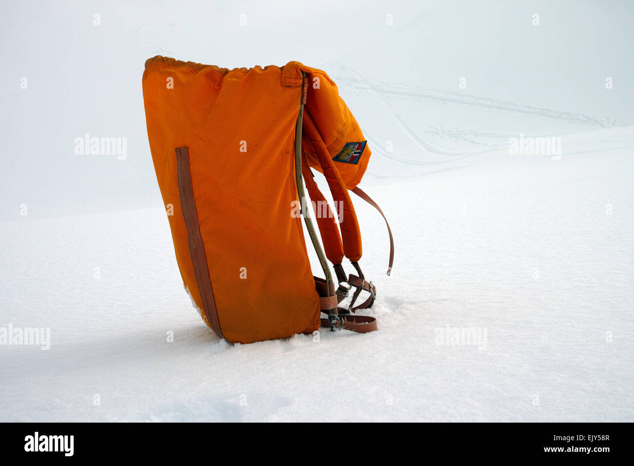 Backpack in snow Stock Photo - Alamy