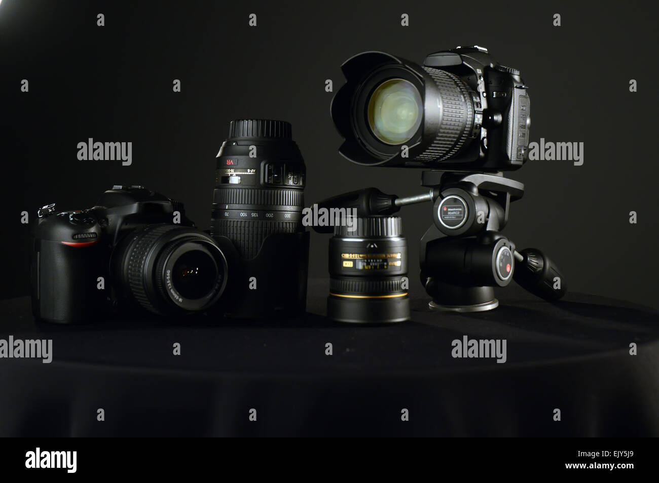 Digital cameras, lenses on a black background Stock Photo - Alamy