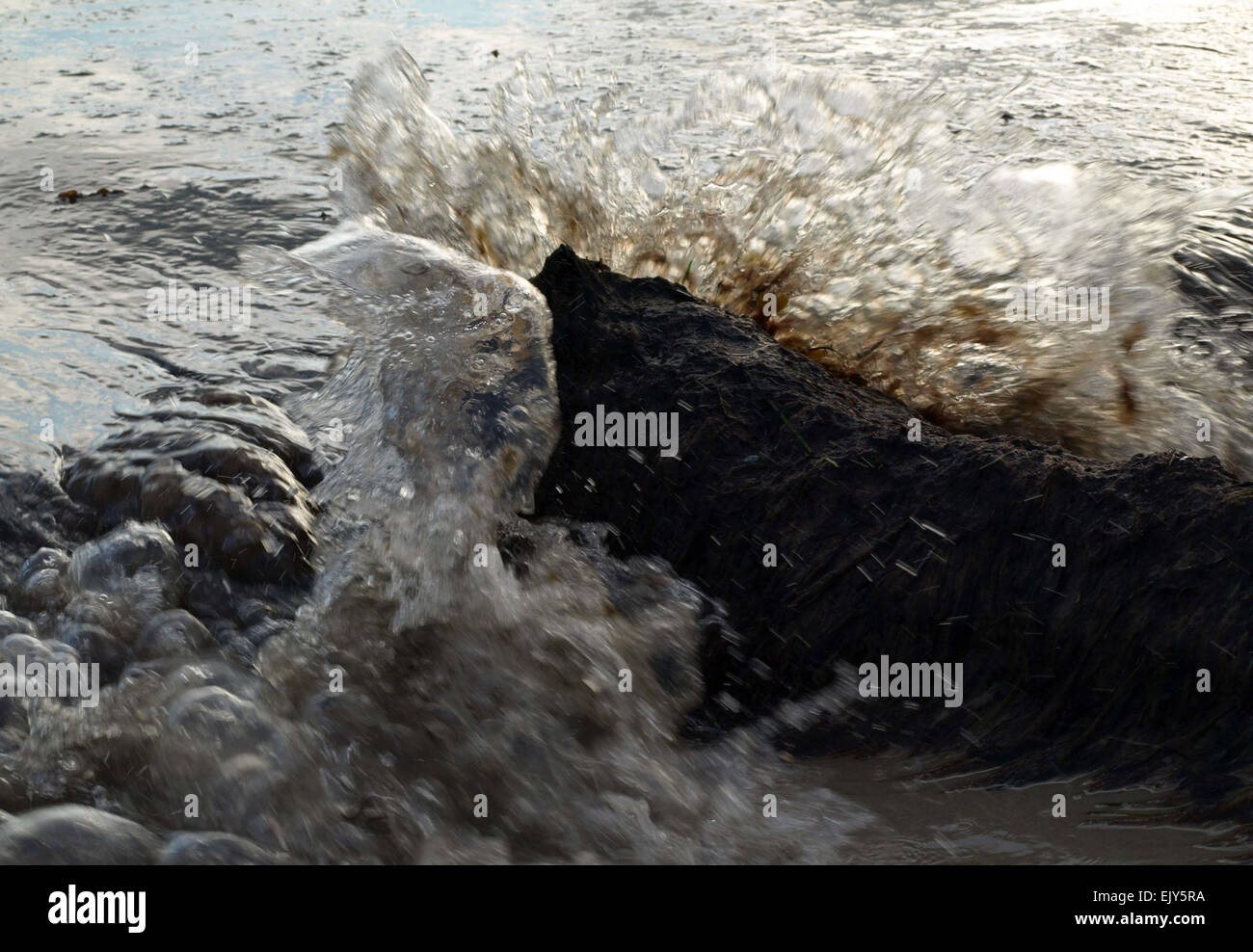 wave hitting a rock Stock Photo - Alamy