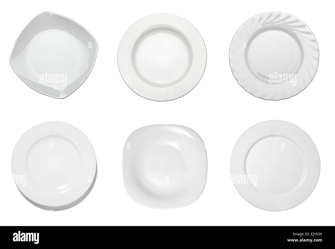 collection of empty white plates on white background. each one is shot ...