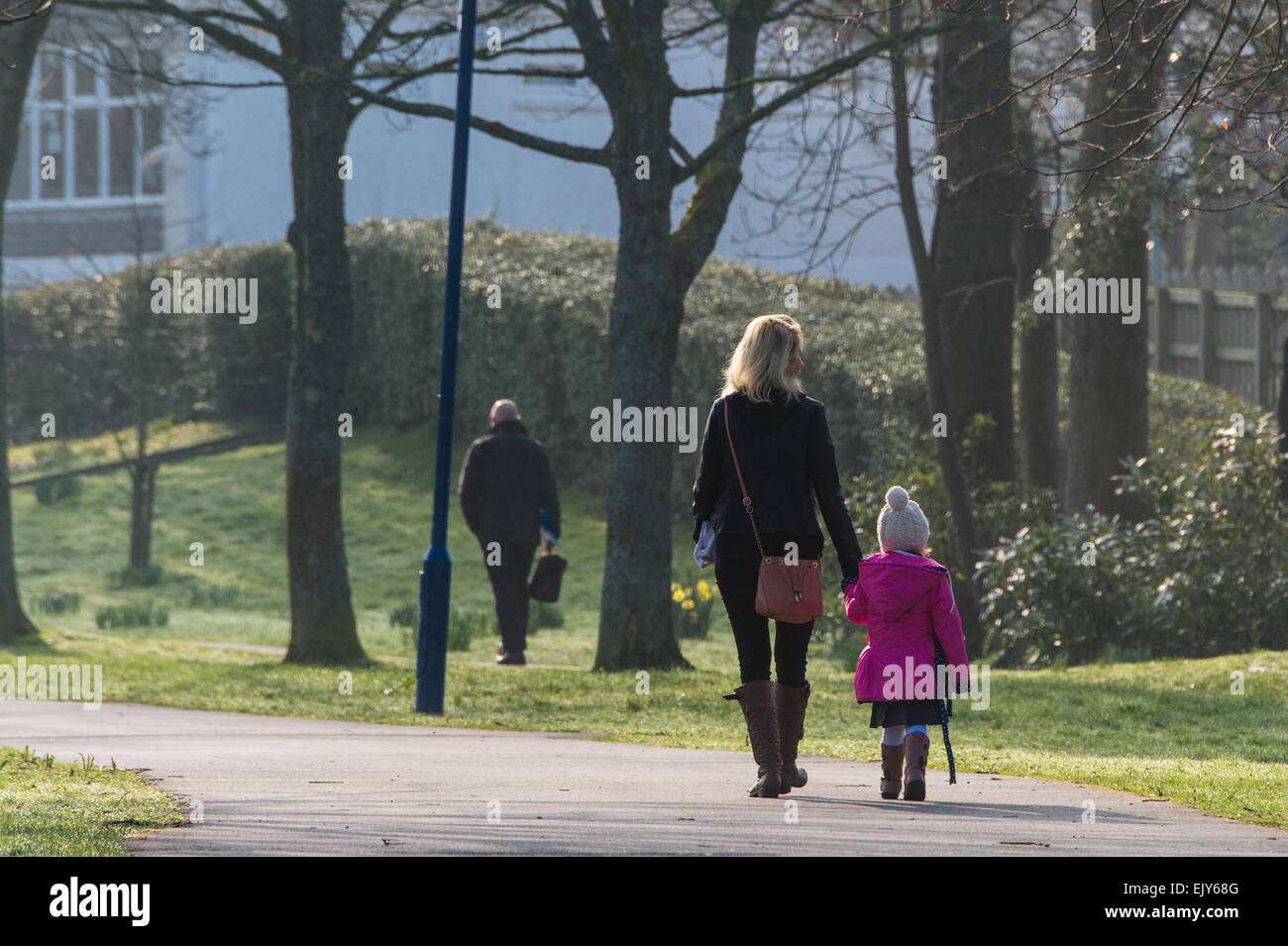 Primary-school age children and their parents walking to primary school ...