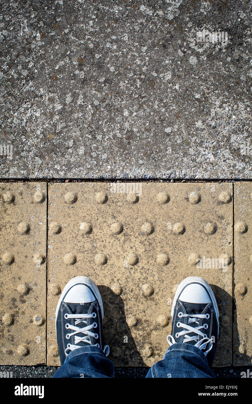 Feet standing on a train platform Stock Photo - Alamy