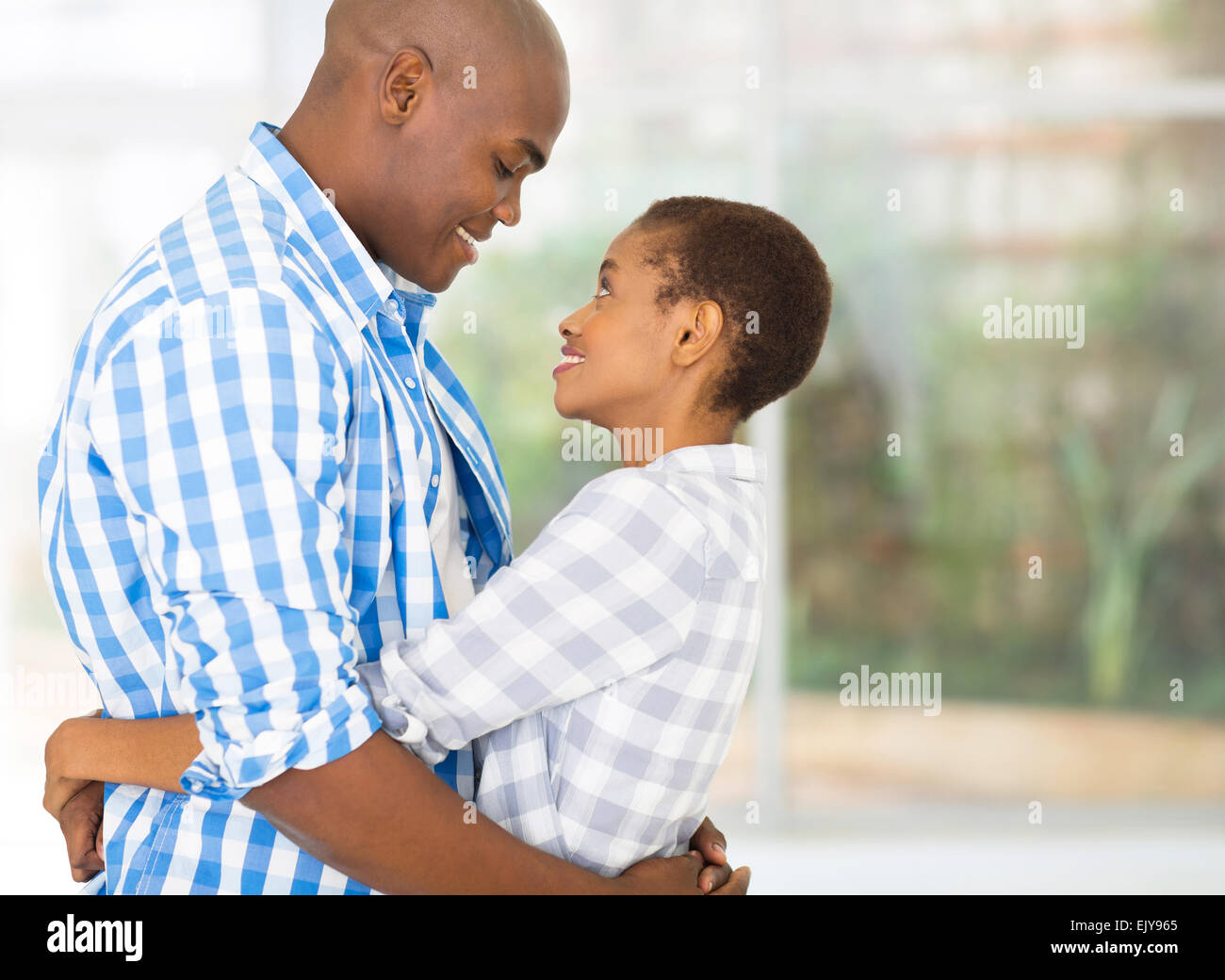 portrait of loving African couple hugging Stock Photo - Alamy