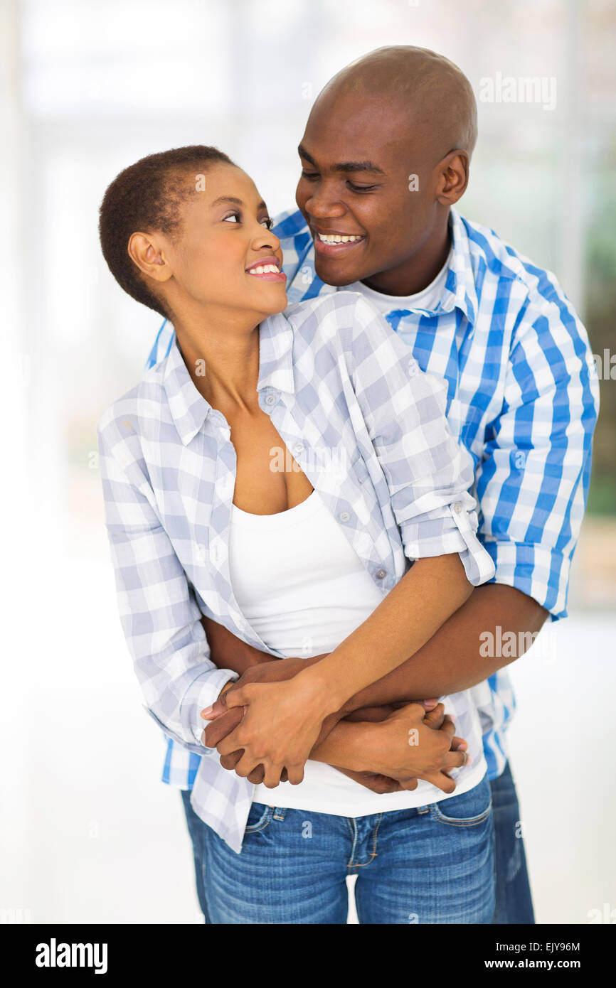 adorable African couple hugging at home Stock Photo - Alamy