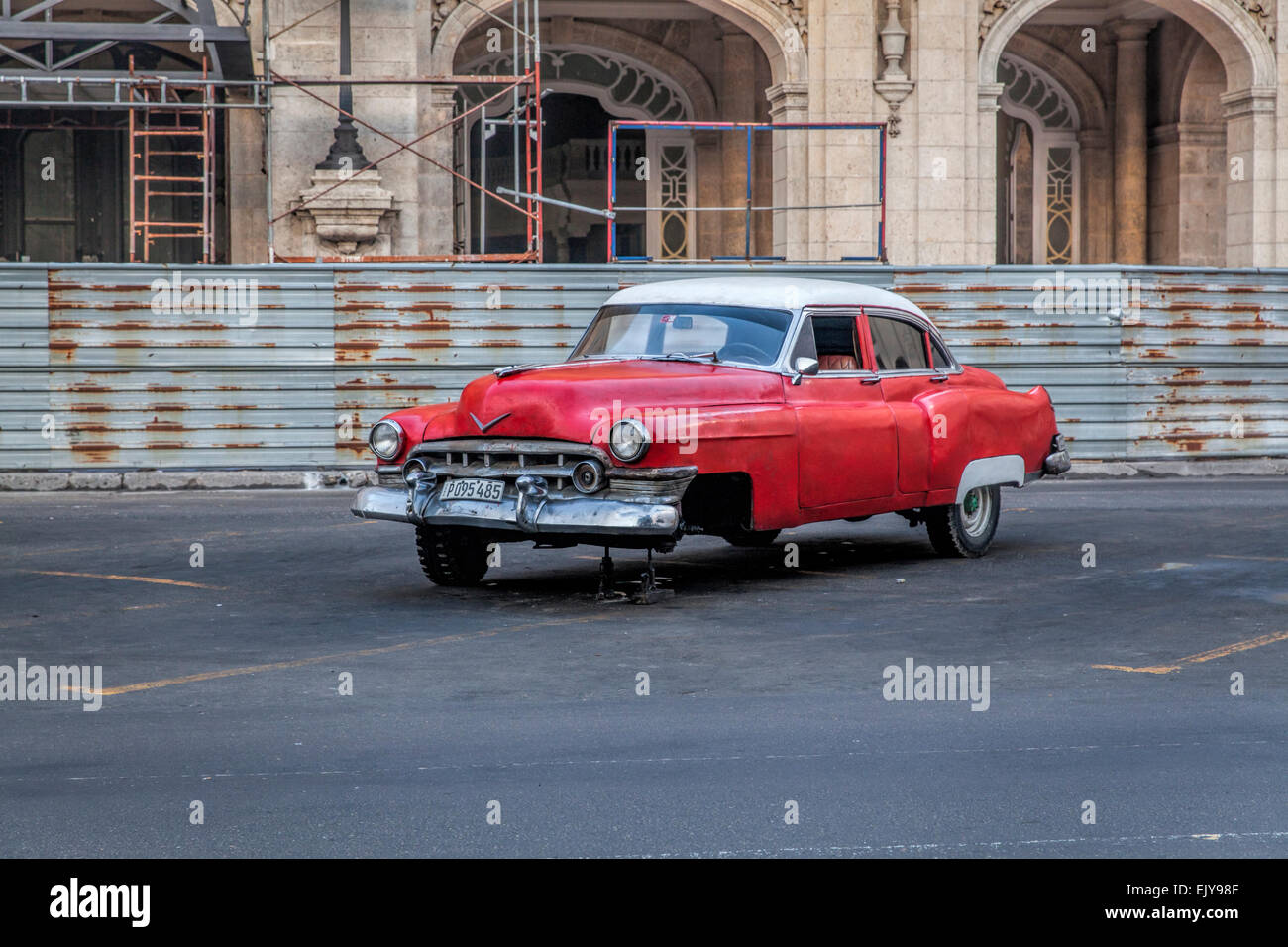 Old American red car outside the Opera House building in Havana with a ...