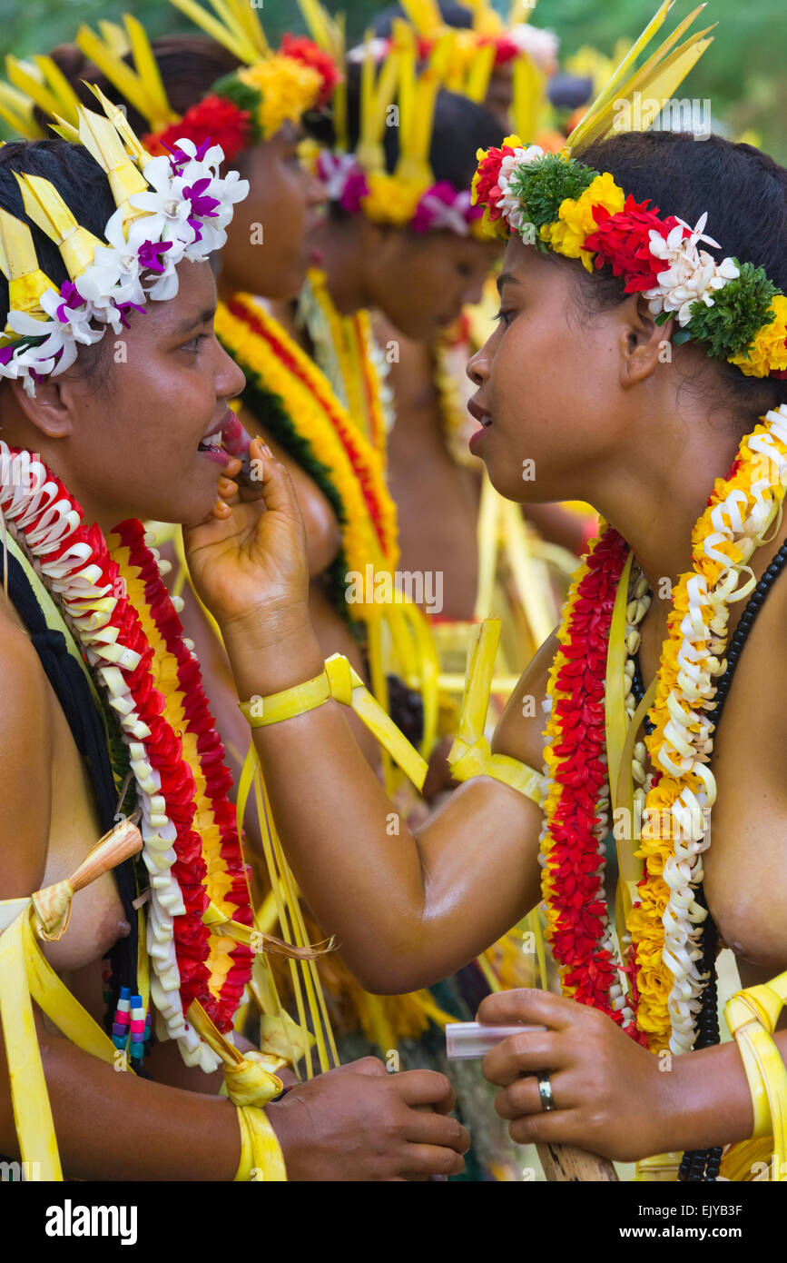 Yapese girls in traditional clothing helping to put on makeup at Yap ...