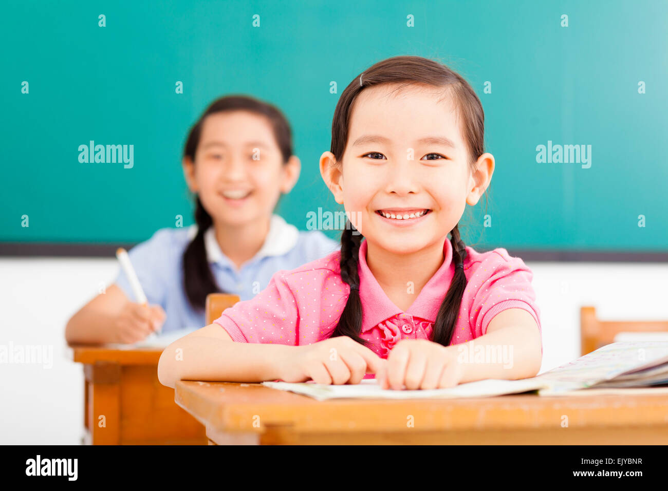 happy little girls in the classroom Stock Photo - Alamy