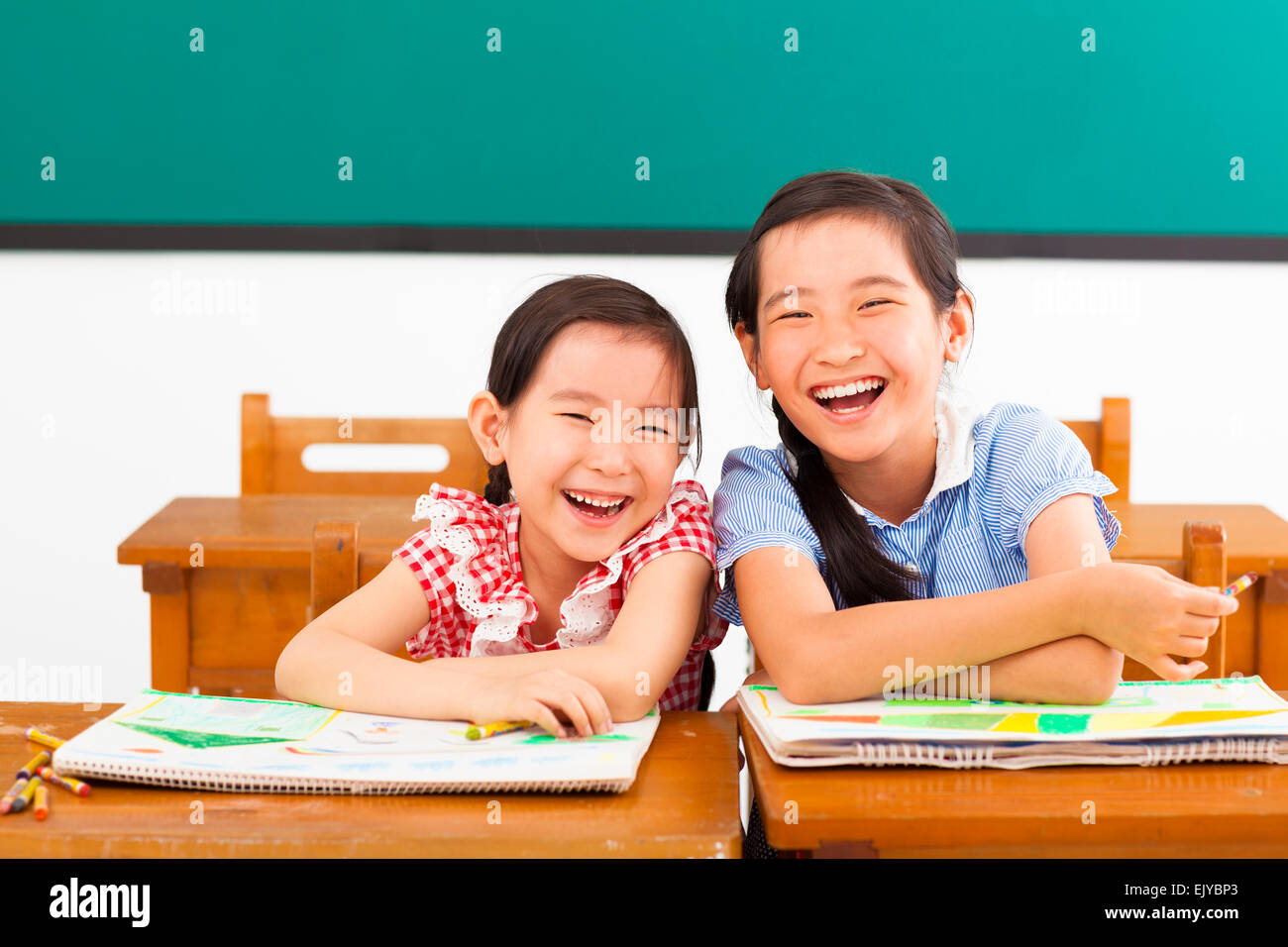 happy little girls in the classroom Stock Photo - Alamy