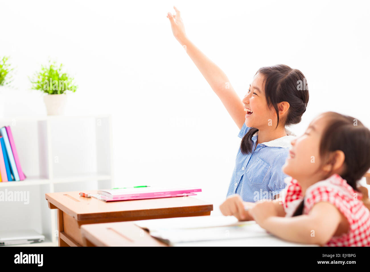 Children with raised hands in classroom hi-res stock photography and ...