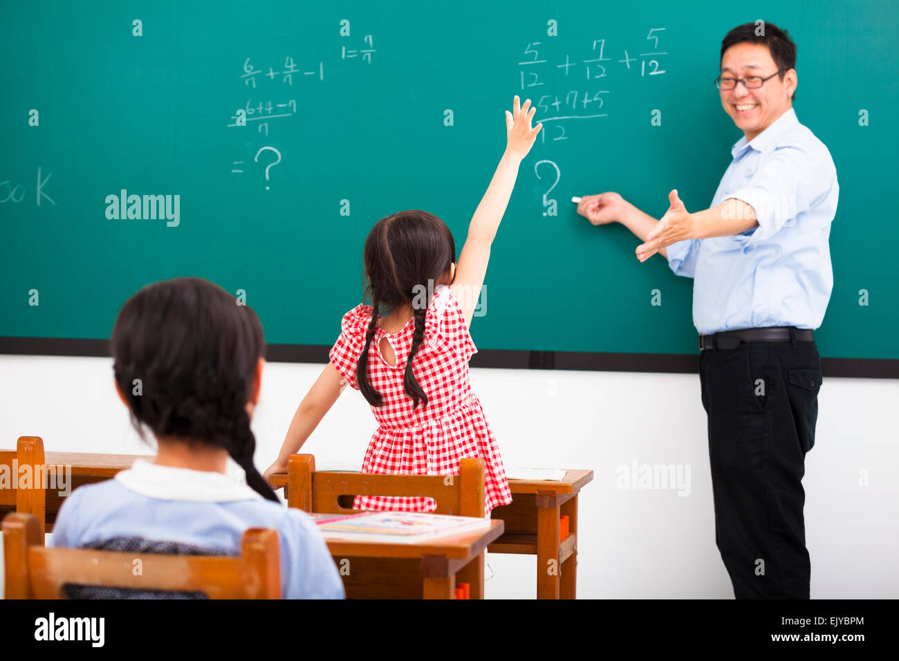 teacher asking question with children in classroom Stock Photo - Alamy