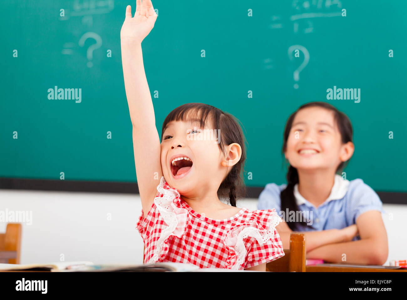 Kids raising hands classroom hi-res stock photography and images - Alamy