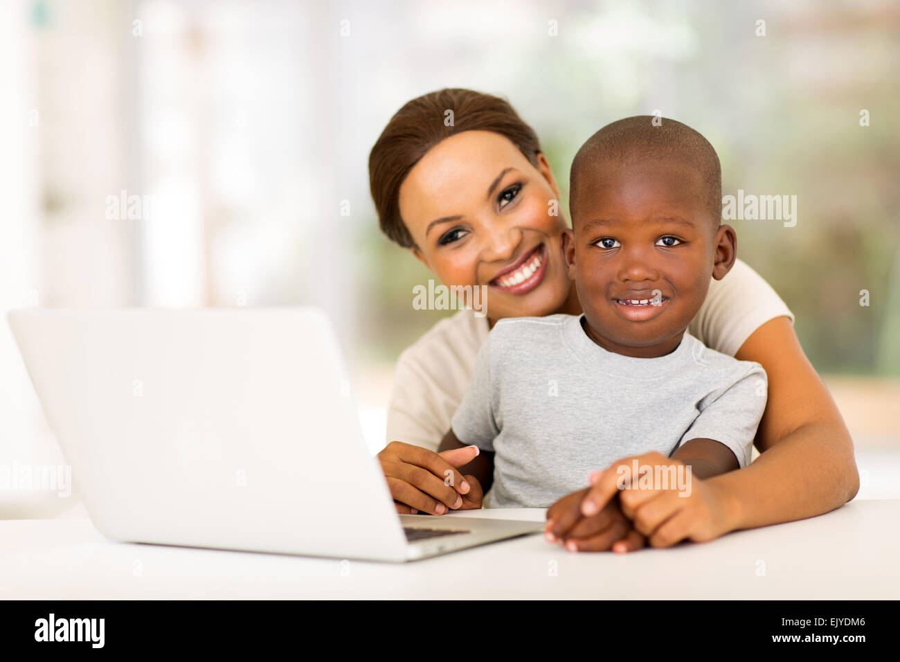 cute little boy and mother with laptop computer at home Stock Photo - Alamy