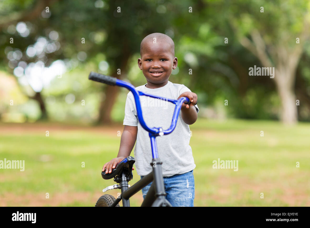 adorable African little boy with his bicycle at the park Stock Photo ...