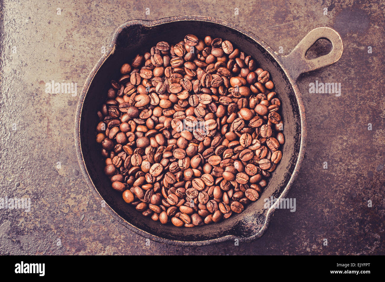Frying pan with coffee beans during roasting Stock Photo - Alamy