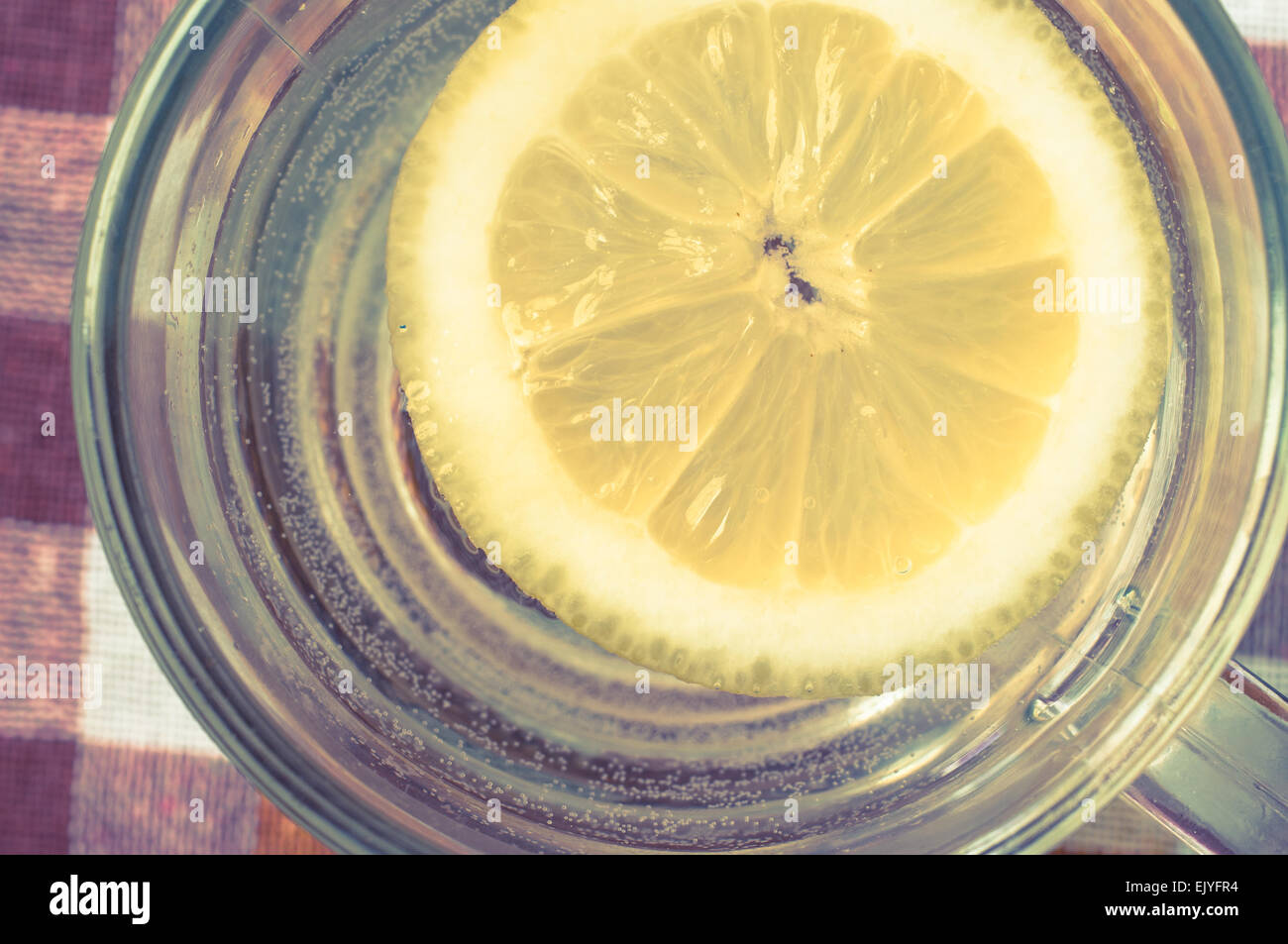 Cup of water with a slice of lemon is on the table. Top view Stock ...