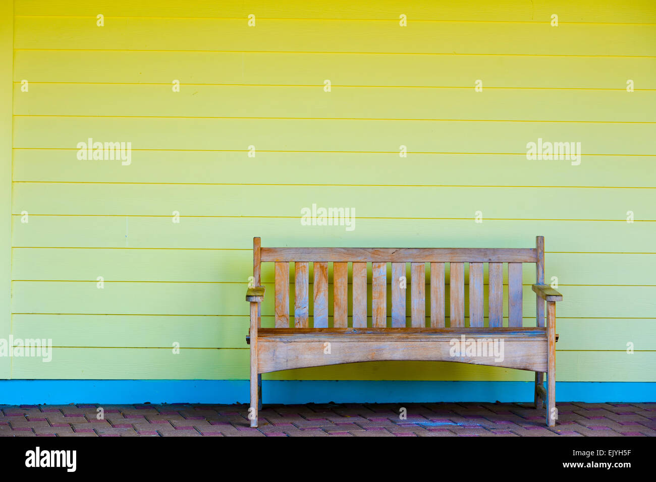 Beautiful wooden bench with yellow decor Stock Photo - Alamy