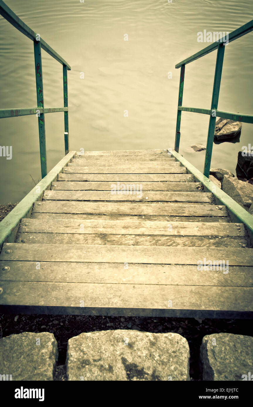wooden steps leading to a pond Stock Photo - Alamy