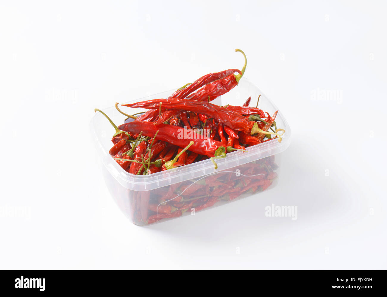 Dried Red Chili Peppers in plastic food container Stock Photo - Alamy