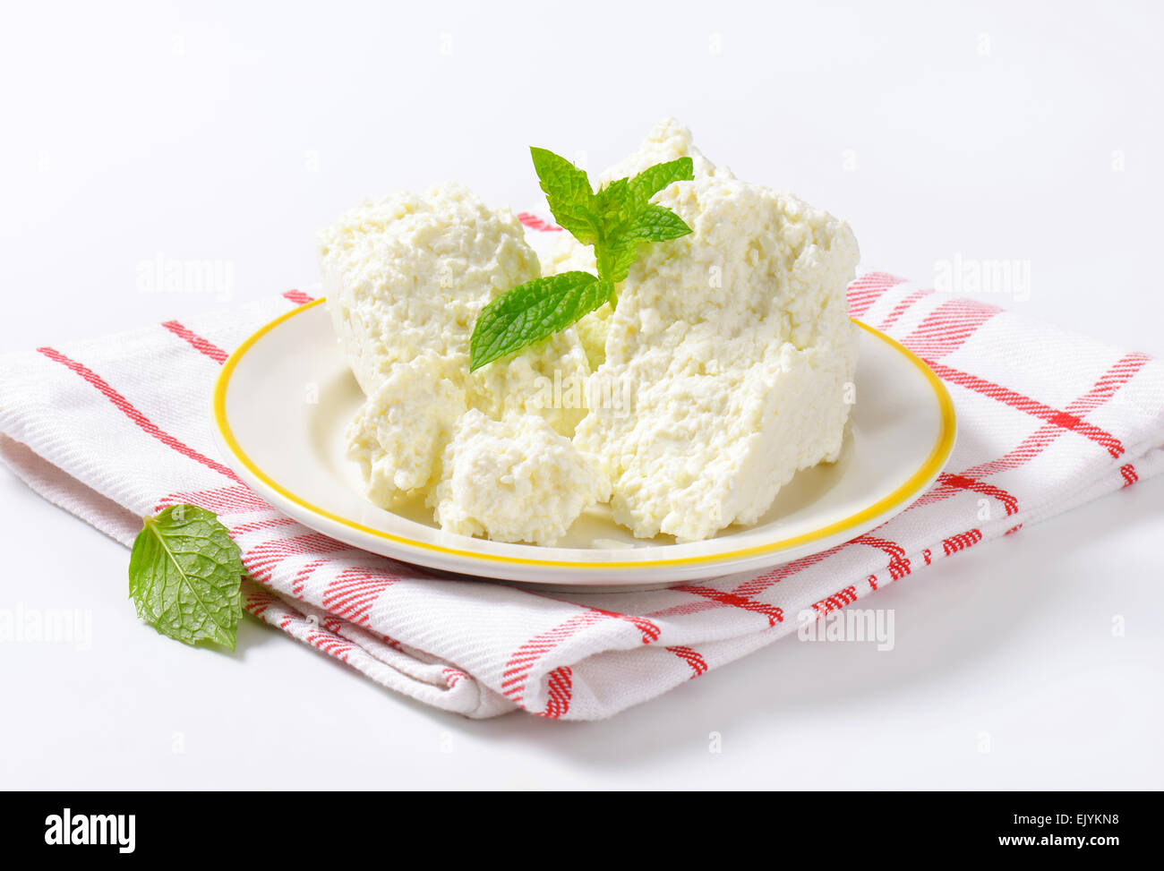 Crumbly white cheese on plate Stock Photo - Alamy