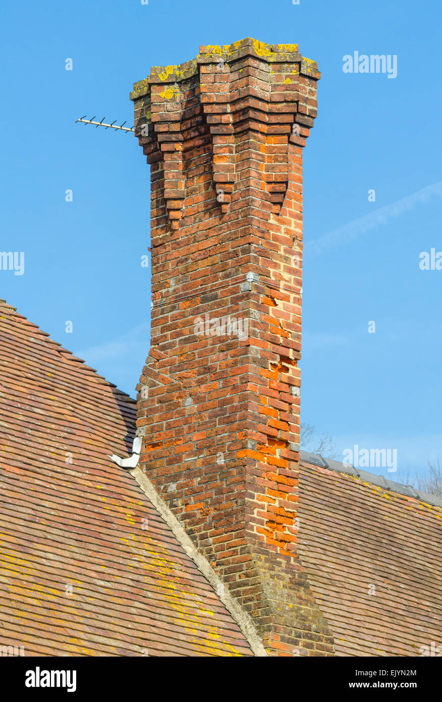 Tall red brick chimney stack on a red tiled roof in England, UK Stock ...