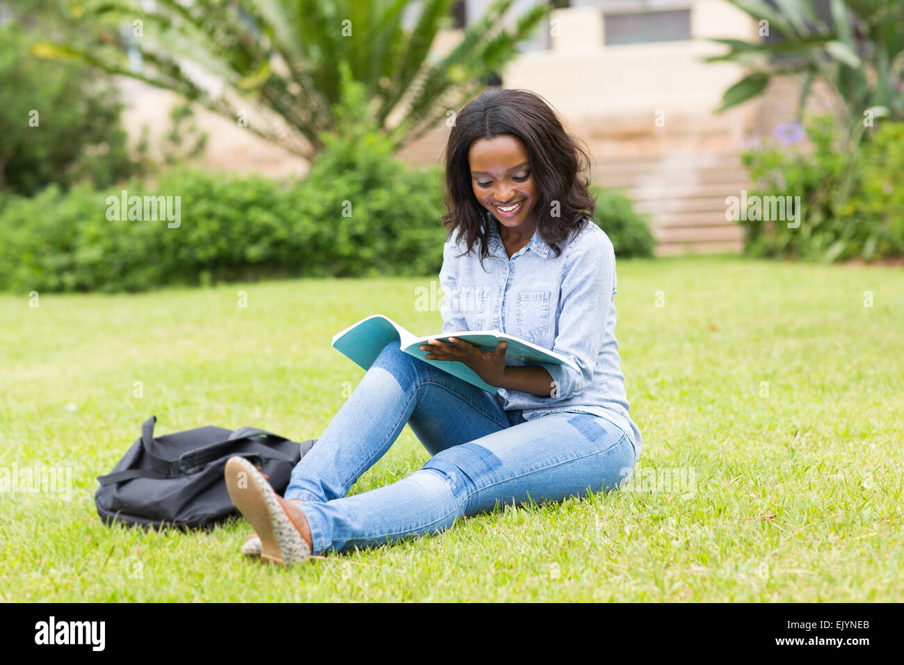 smart African American college student reading outdoors Stock Photo - Alamy