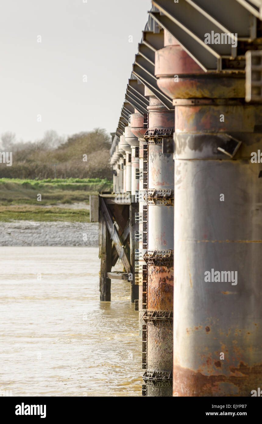 Support pillars of a rail bridge crossing a fast flowing river Stock ...
