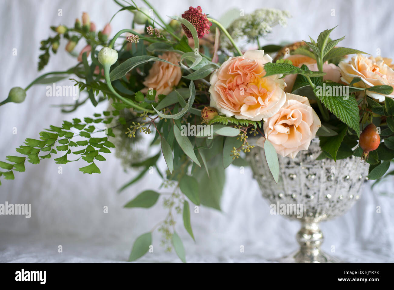 Formal floral arrangement of roses in silver urn Stock Photo - Alamy