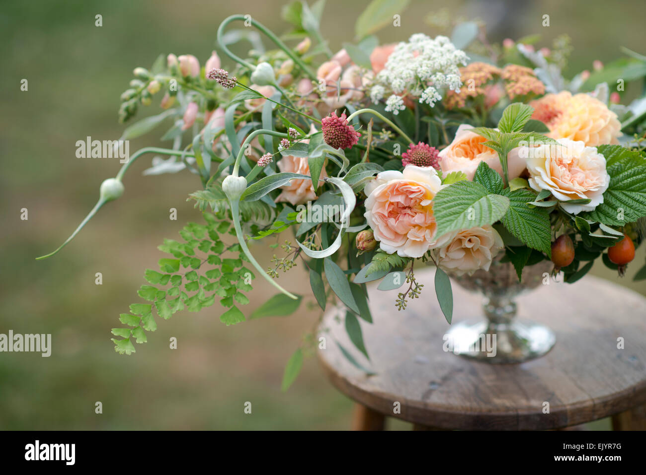 Formal floral arrangement of roses in silver urn Stock Photo - Alamy