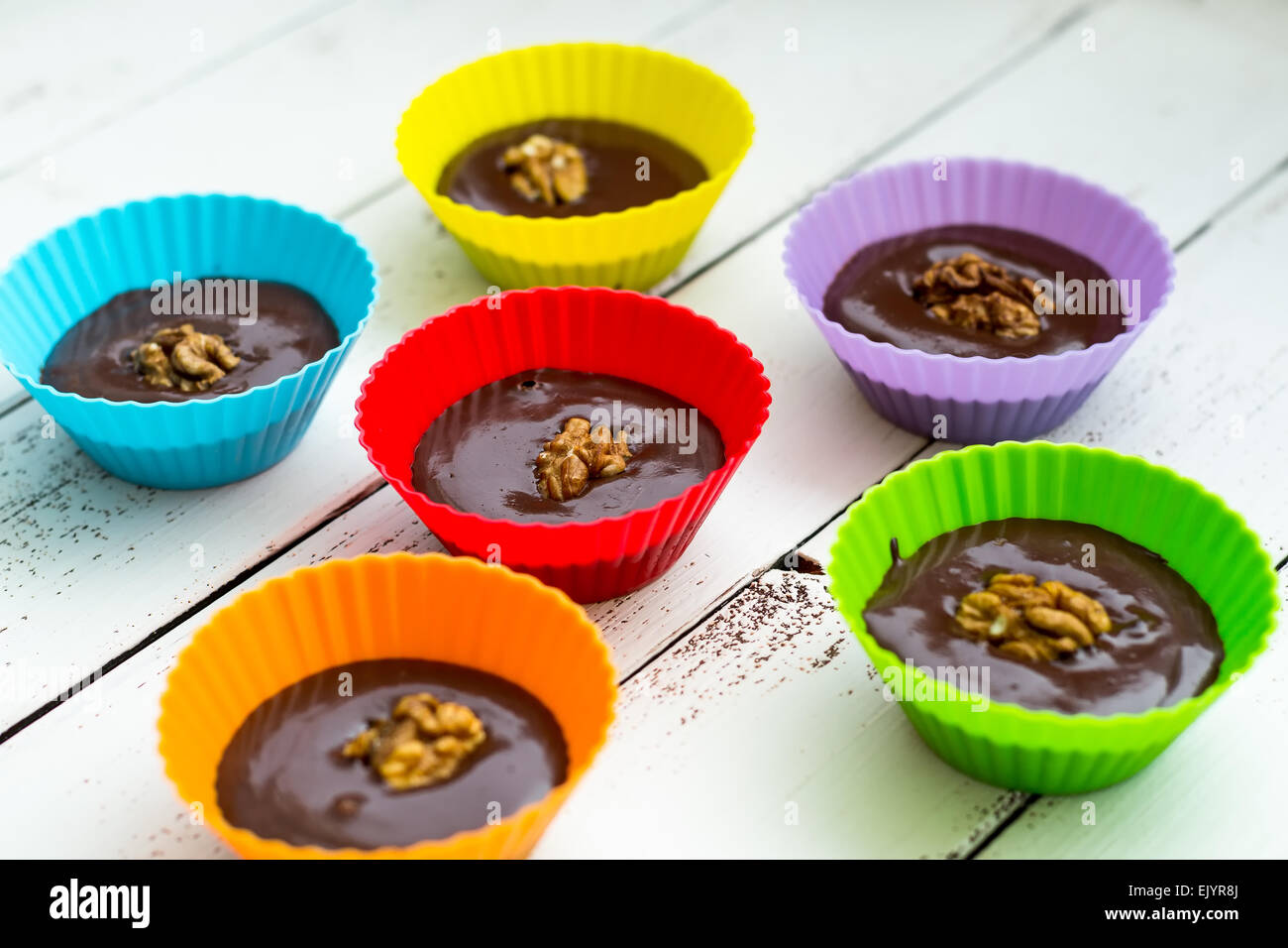 Chocolate Truffles in Colorful Cups on White Wooden Table Stock Photo ...