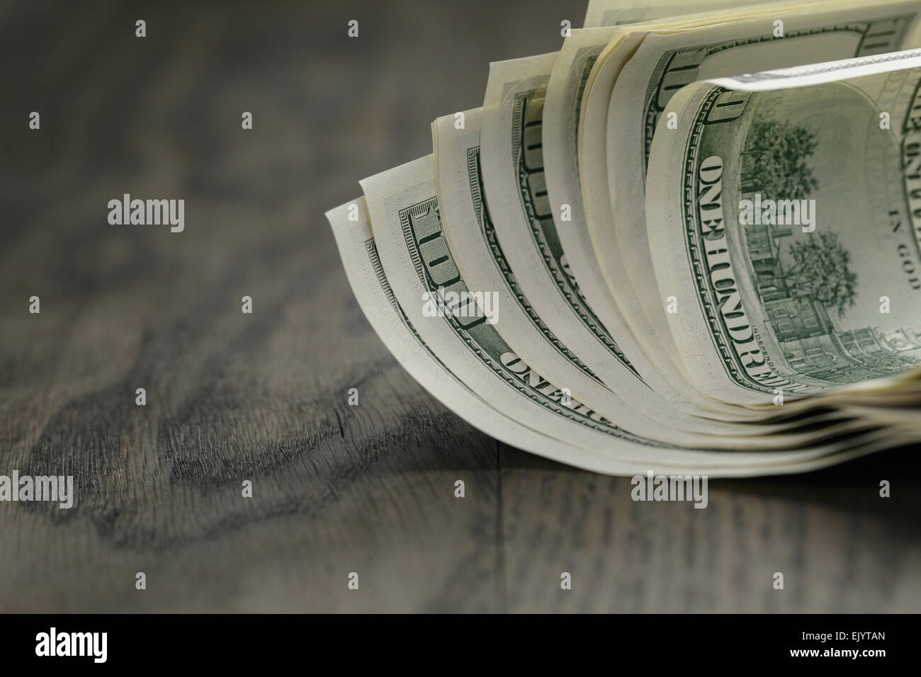 hundred dollar bills on wood table Stock Photo - Alamy
