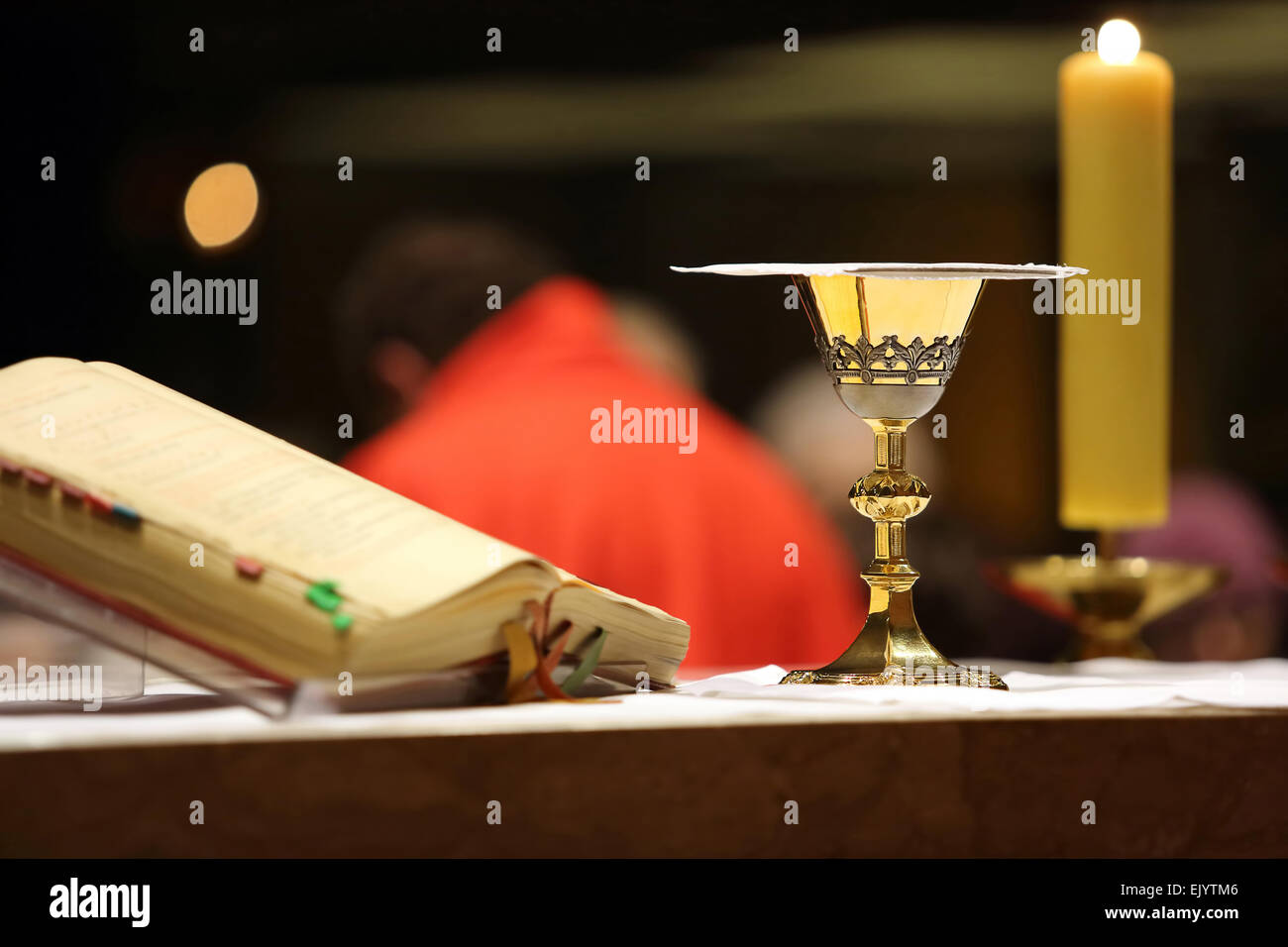 Golden chalice on the altar during the distribution of Holy Communion ...