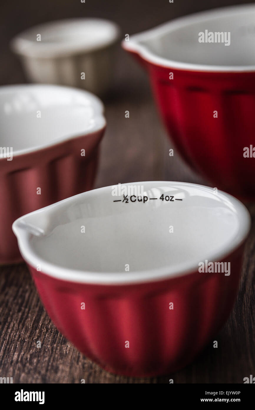 Empty colorful measuring cups on dark brown wooden table Stock Photo ...