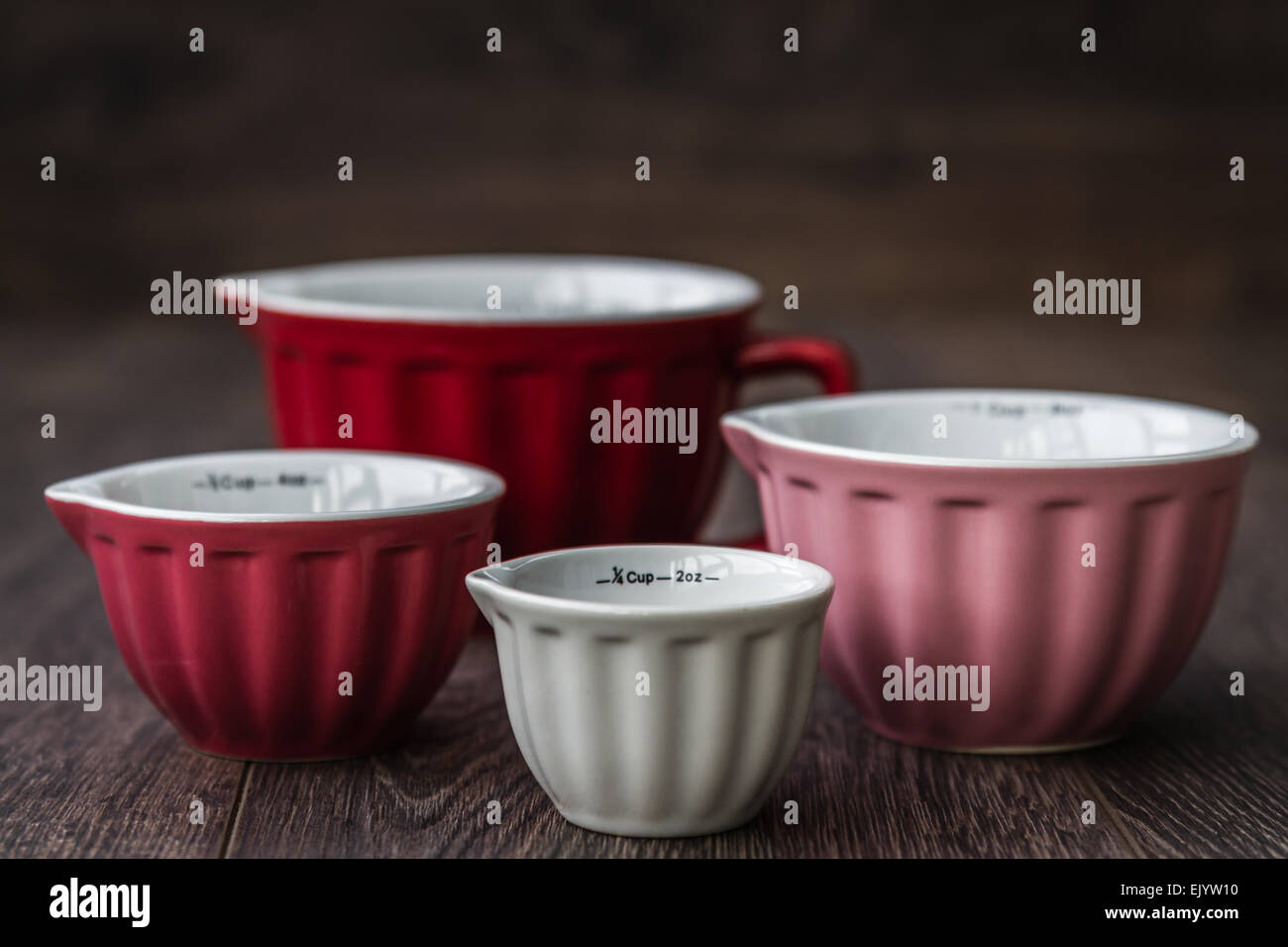 Empty colorful measuring cups on dark brown wooden table Stock Photo ...
