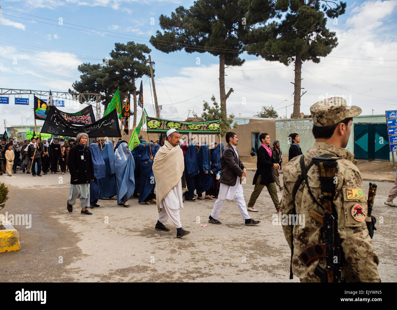Women in blue burqas participate in street procession in the Day of ...