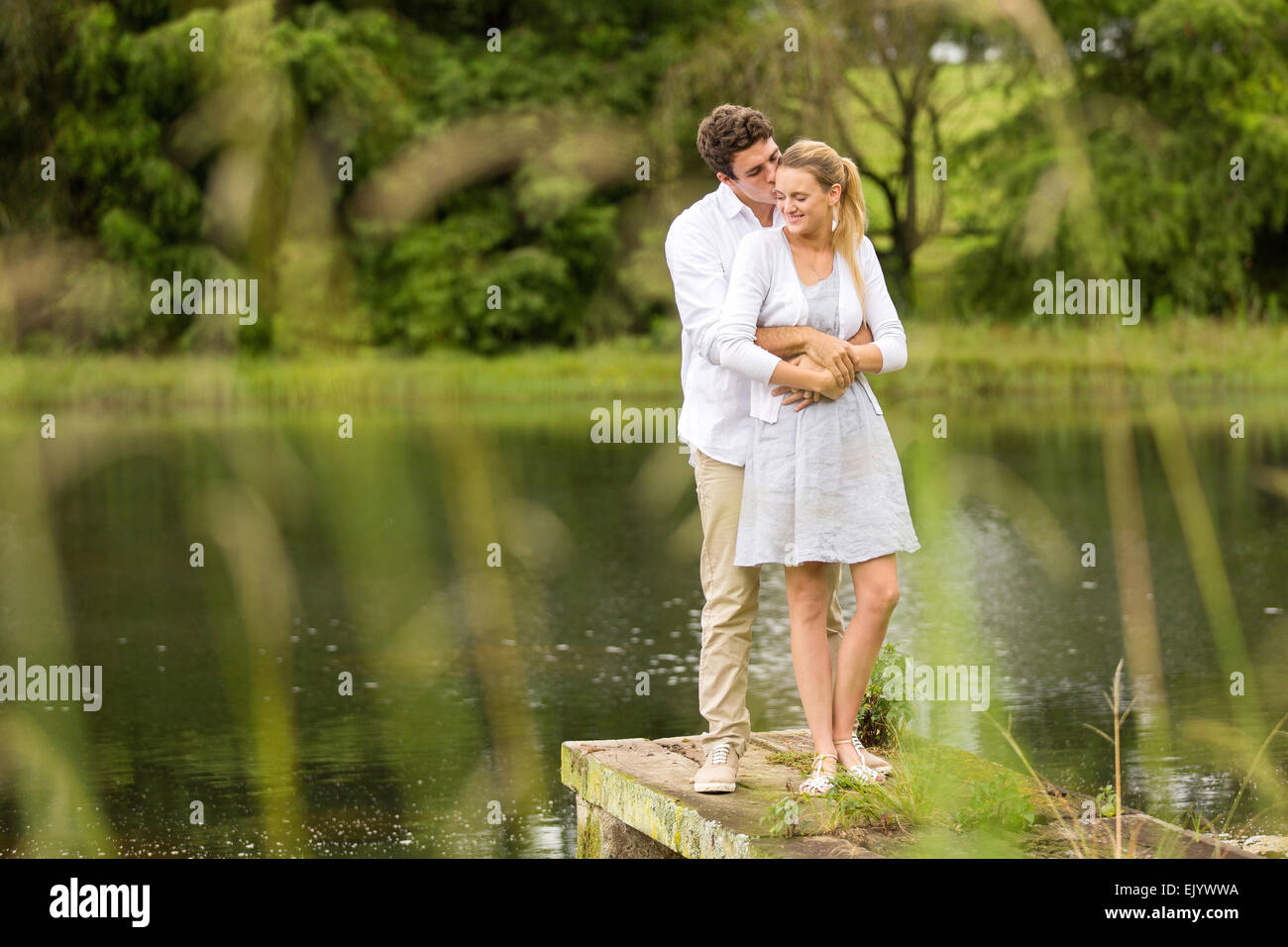 romantic young couple standing by the river Stock Photo - Alamy