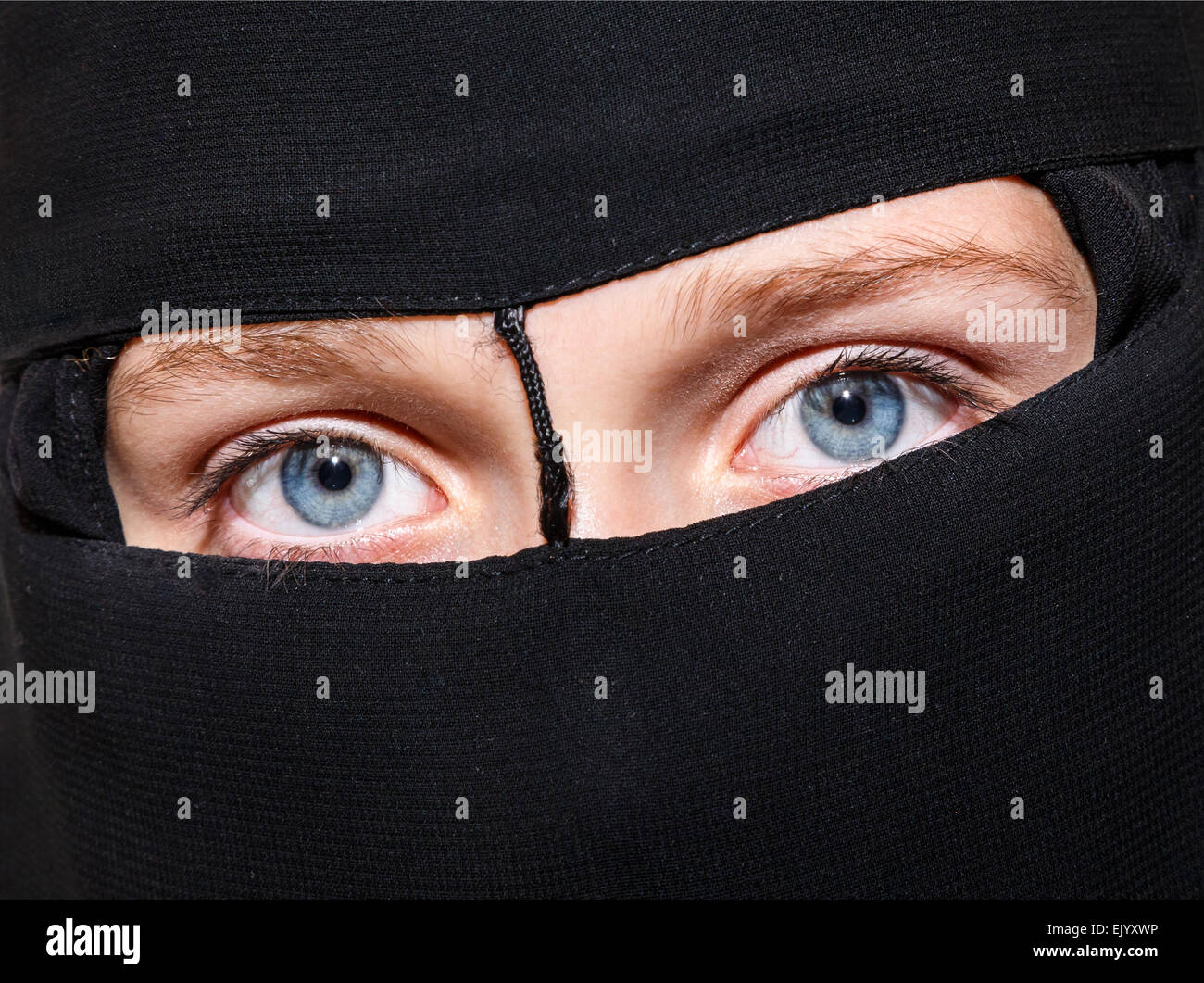 Unrecognizable young beauty hidden from view behind the traditional ...