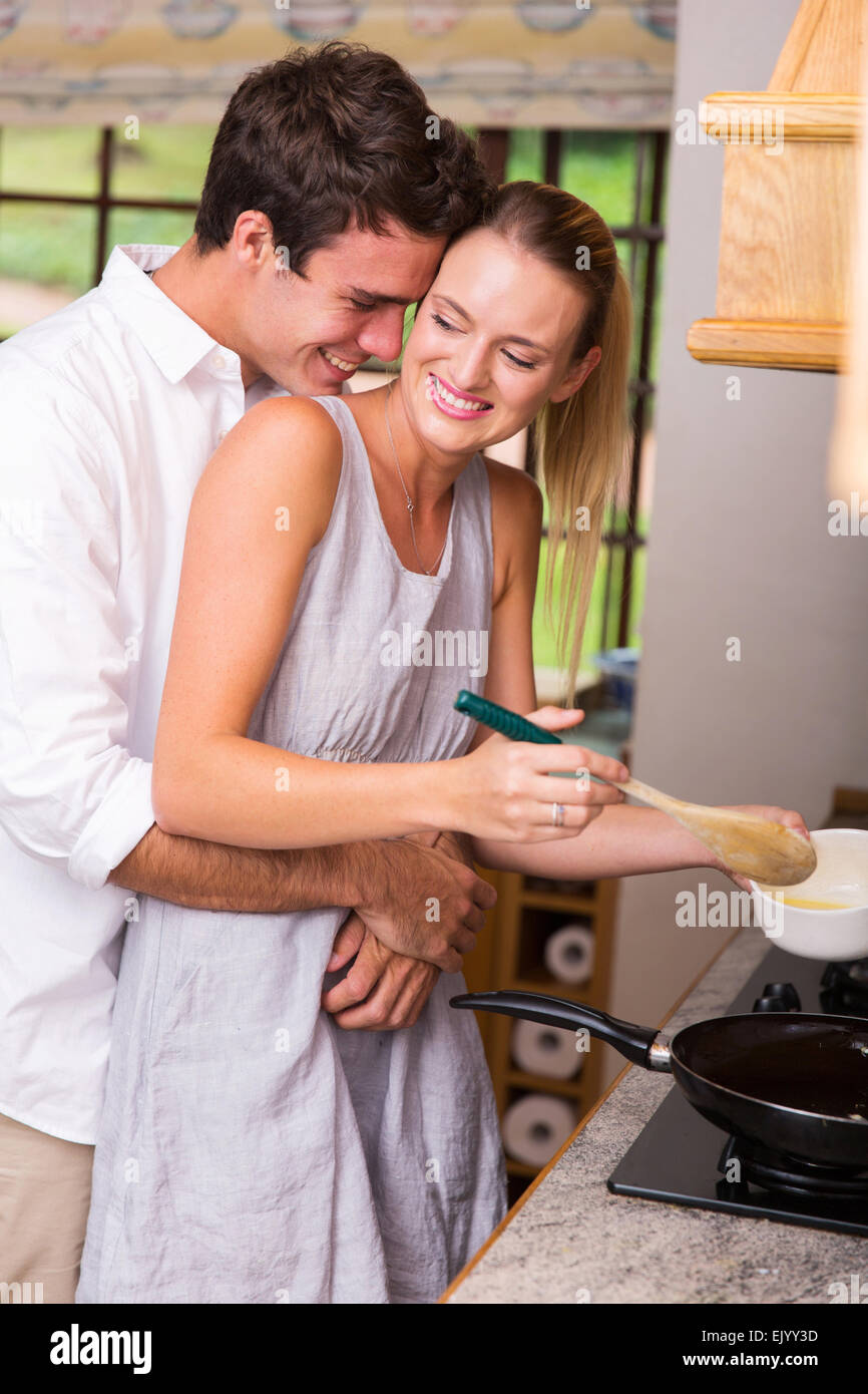 lovely young couple cooking together in kitchen Stock Photo - Alamy
