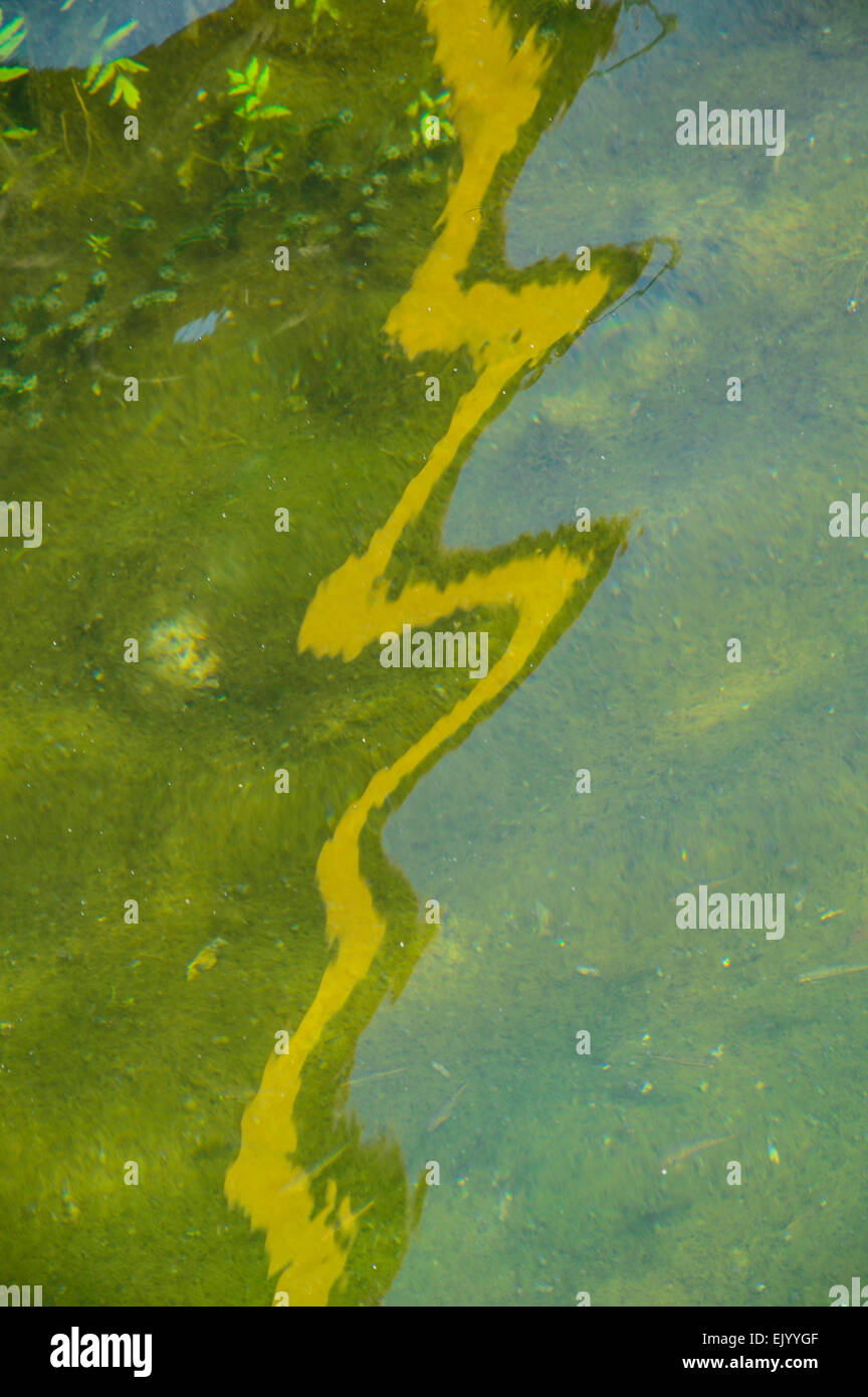 reflection of a yellow line on a river surface Stock Photo - Alamy