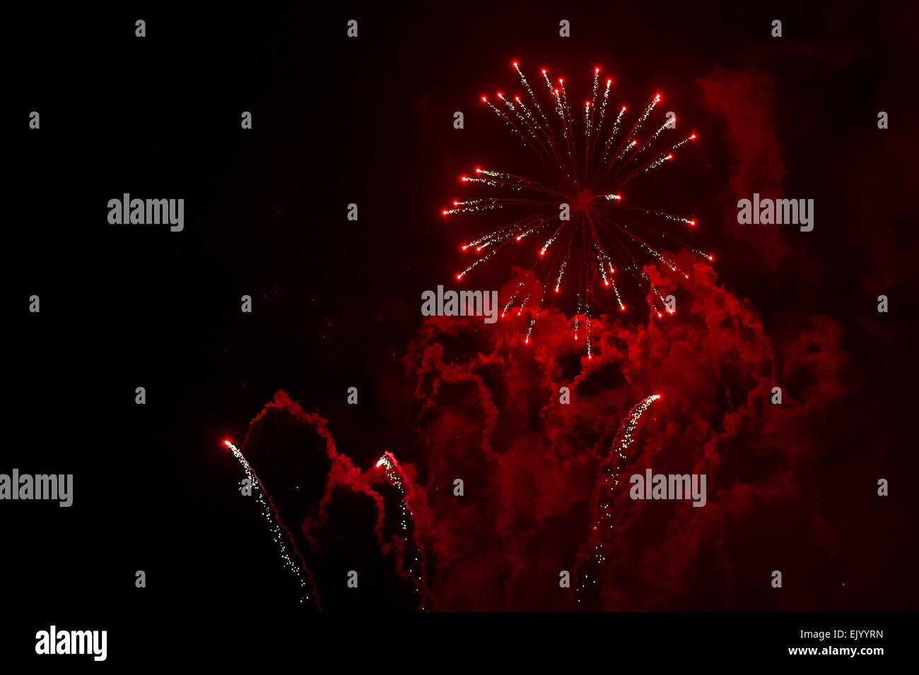 Fireworks exploding at night with a trail of smoke Stock Photo - Alamy