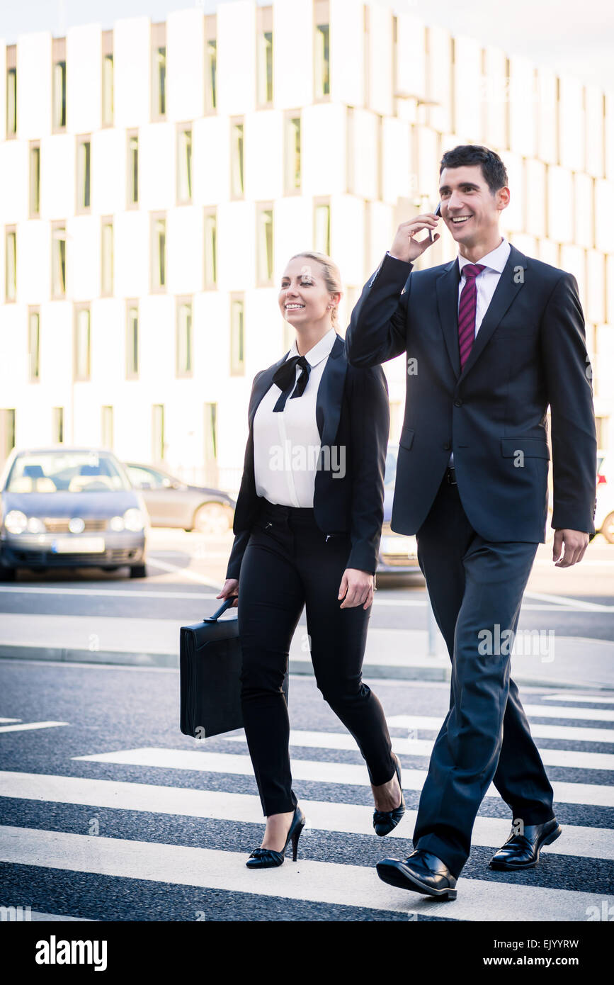 Business people in front of office building wearing briefcase and ...