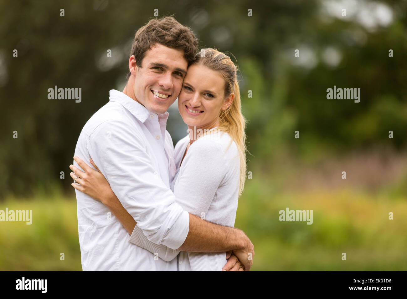 portrait of young couple hugging outdoors Stock Photo - Alamy